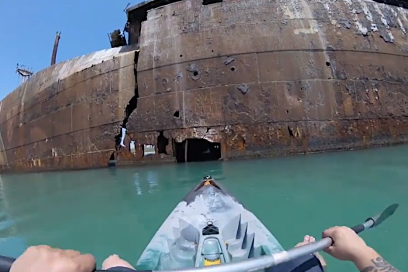 Kayaker Paddles Inside and Explores the Interior of a Rusty, Abandoned ...